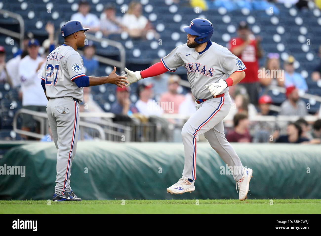 Texas Rangers' Jake Burger celebrates his home run with third base ...