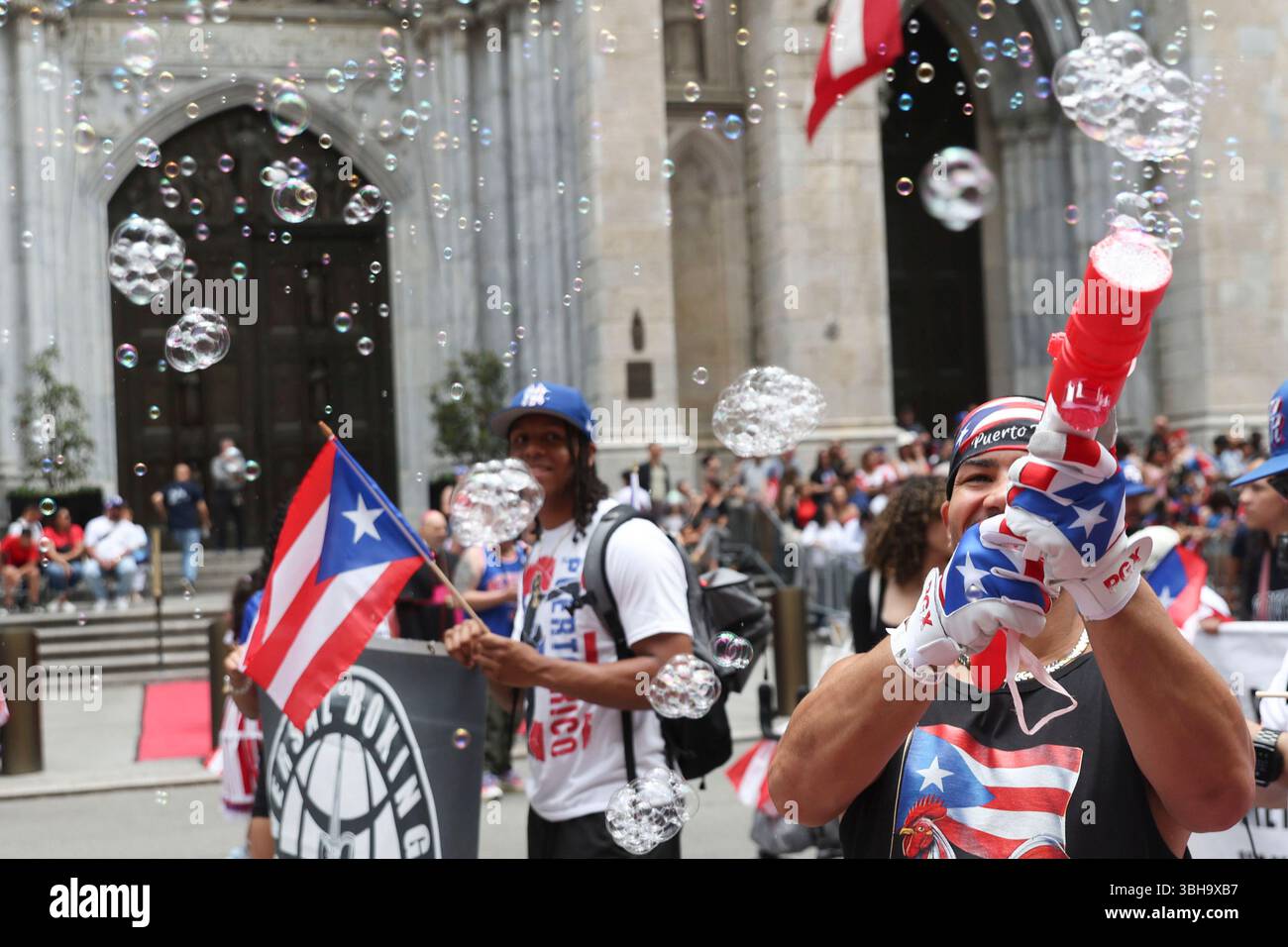 A bubble machine is used as the Puerto Rican Day Parade makes its way ...