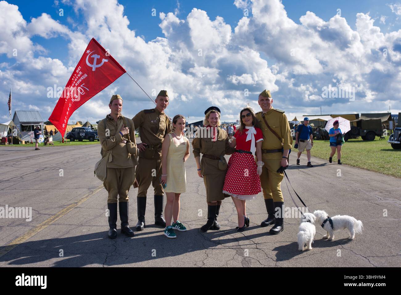 A group of people dressed in Soviet military uniforms and 1950s attire ...