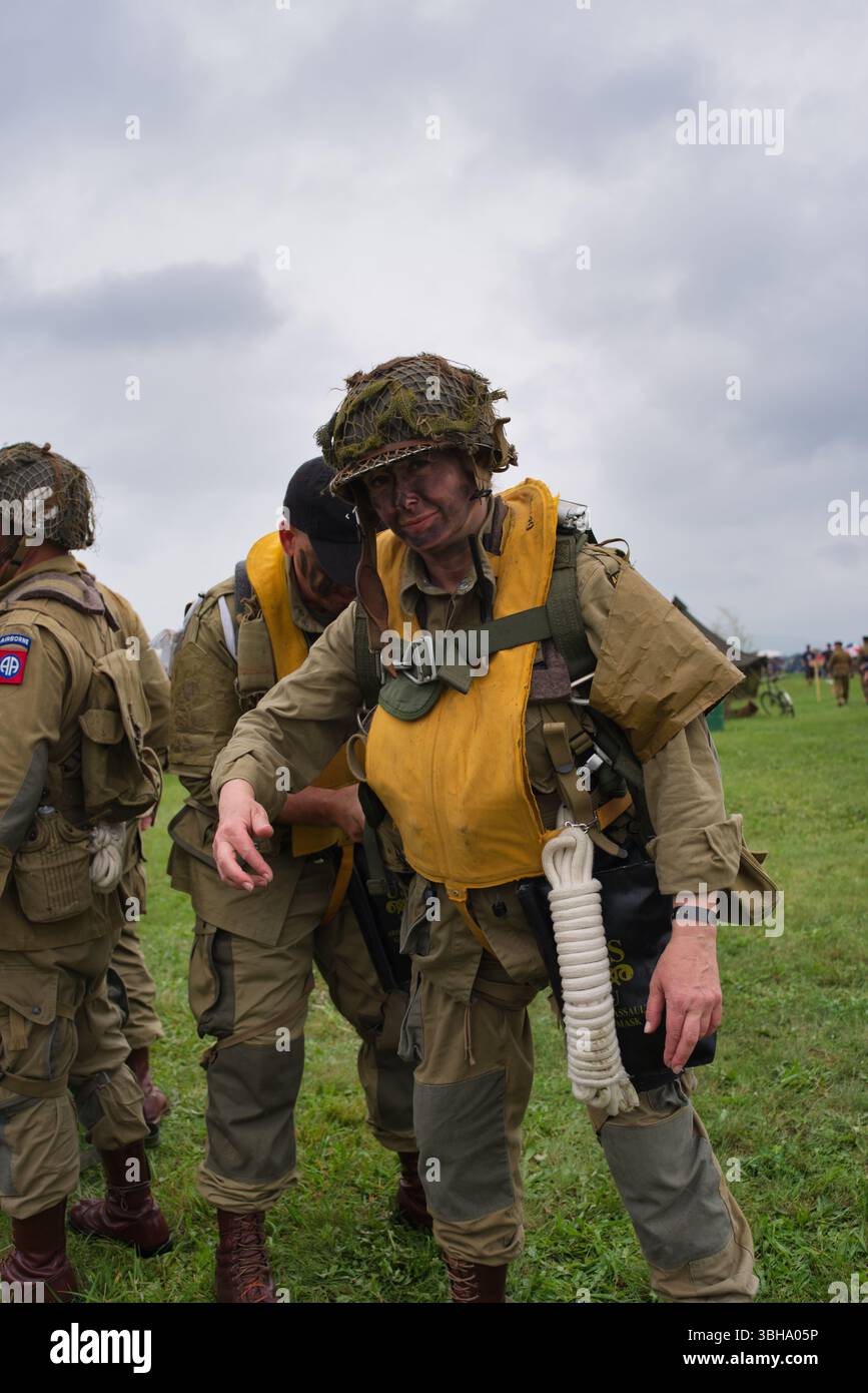 Three soldiers in WWII-era US Army paratrooper uniforms. One soldier is ...