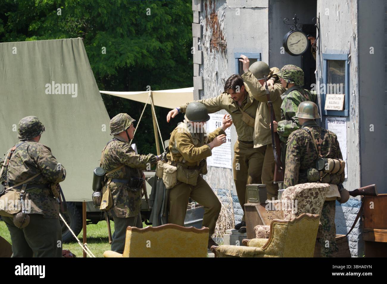 World War II reenactors in German and American uniforms engage in a ...