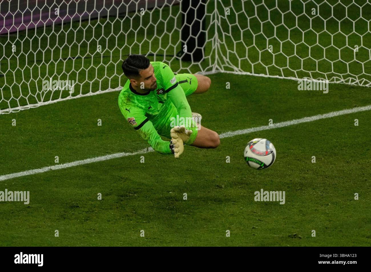 Portugal goalkeeper Diogo Costa stops a penalty shot by Spain's Alvaro Morata during the Nations ...