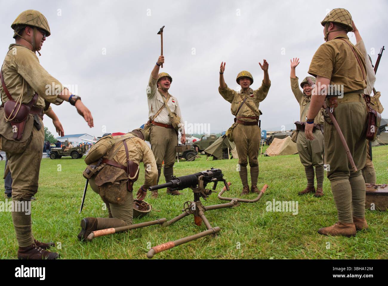 Five men in WWII Japanese army reenactment uniforms surround a ...