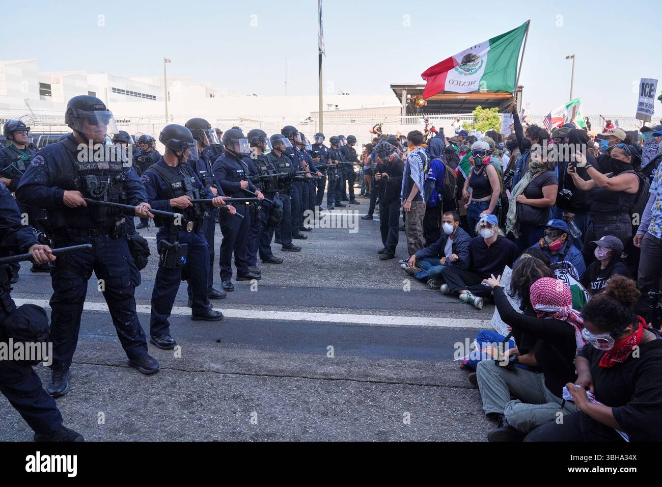 Protesters confront a line of police near the metropolitan detention ...