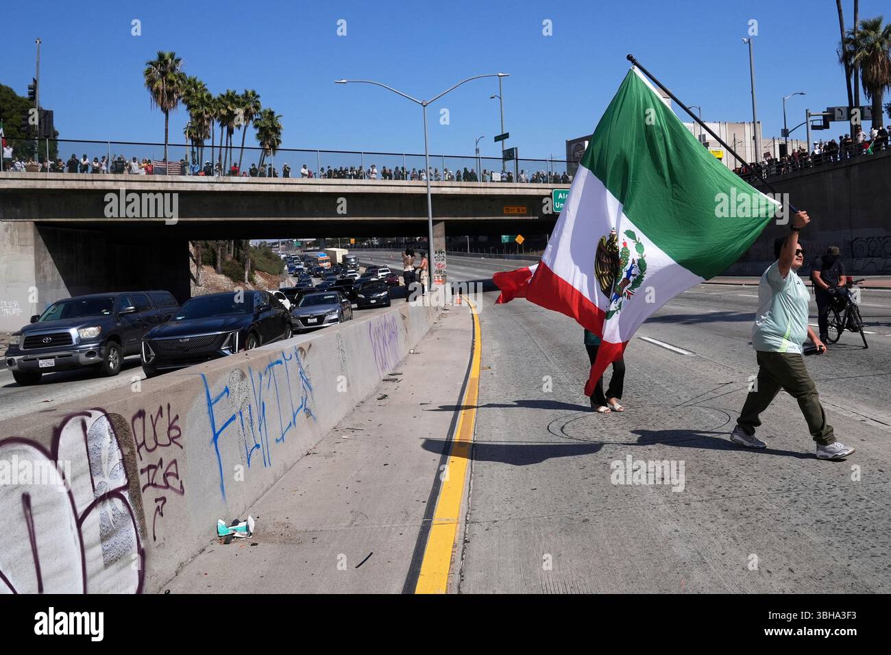 Protesters block the 101 Freeway near the metropolitan detention center ...