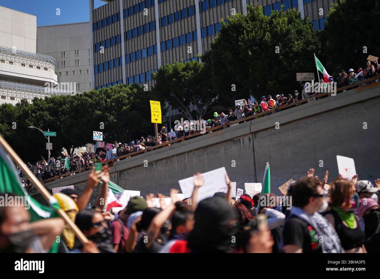 Protesters block the 101 Freeway near the metropolitan detention center ...