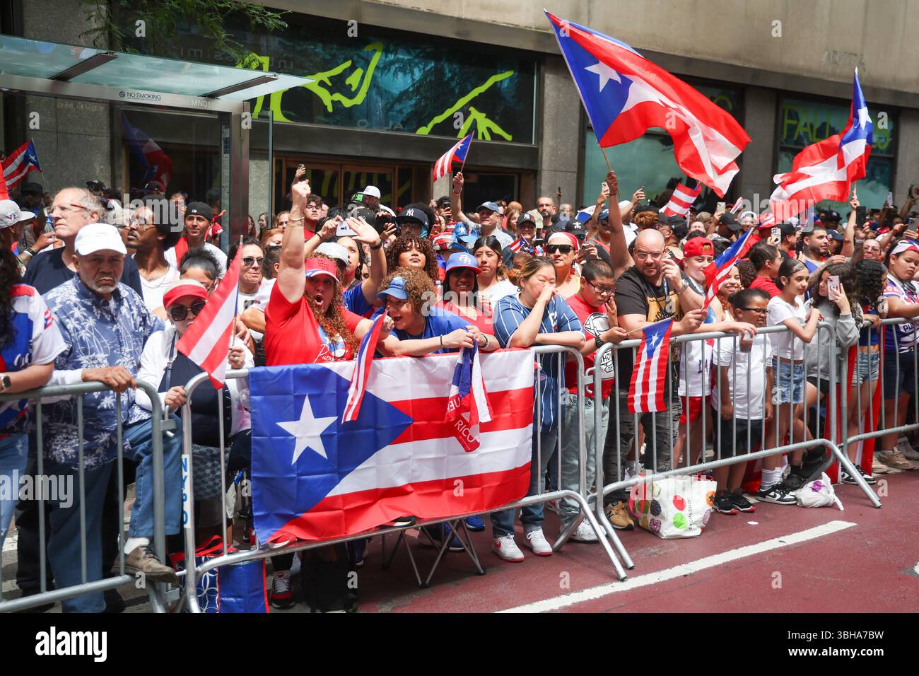 People dressed in red, white and blue wave Puerto Rico flags during the ...