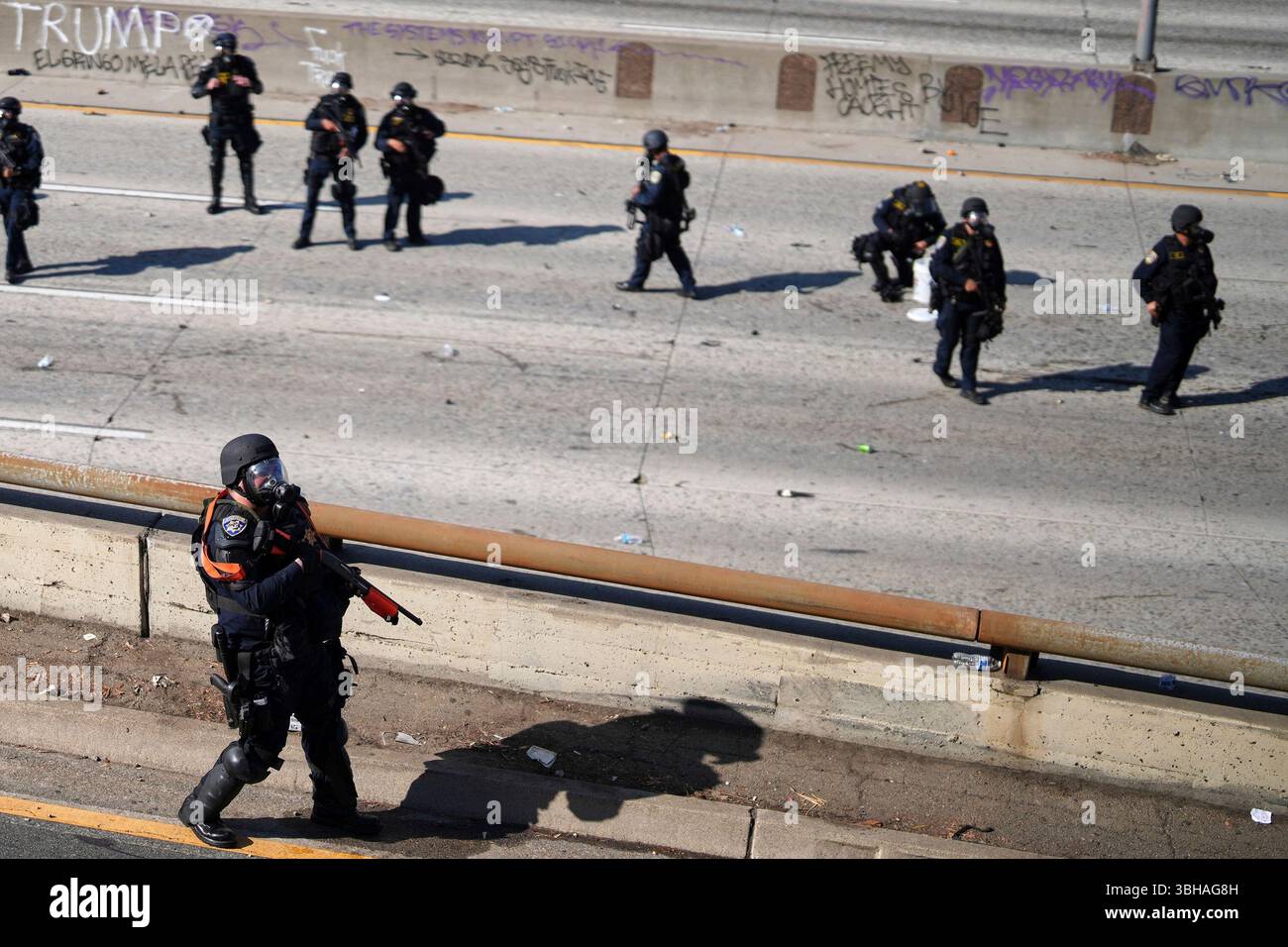 Police officers are seen on the 101 Freeway near the metropolitan ...