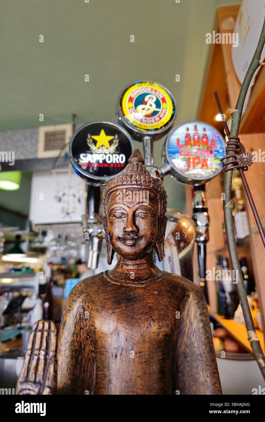 A Buddha statue by Draft Beer faucets at the popular Jaybird bar ...