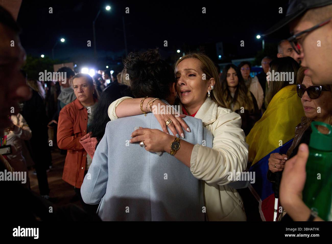 People hug each other outside the clinic where Colombian Sen. Miguel ...