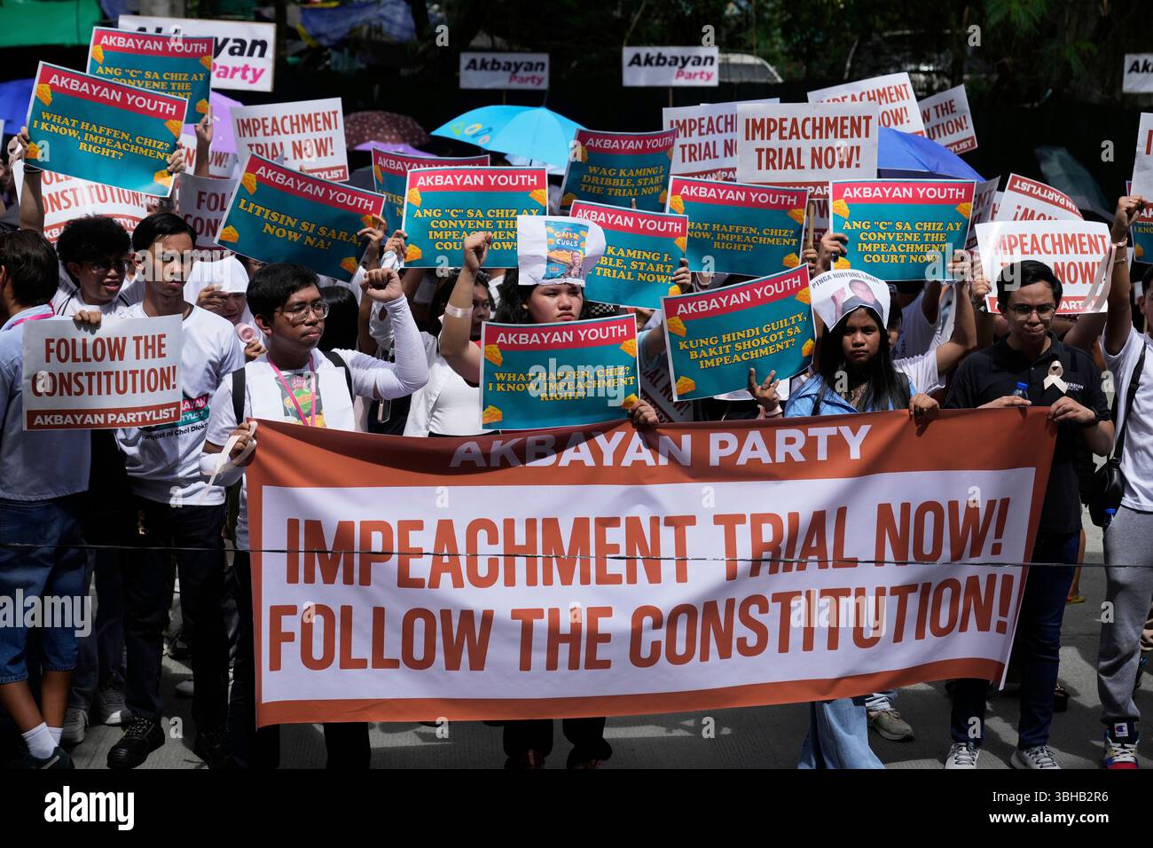 Protesters hold slogans during a rally to call for the start of the ...