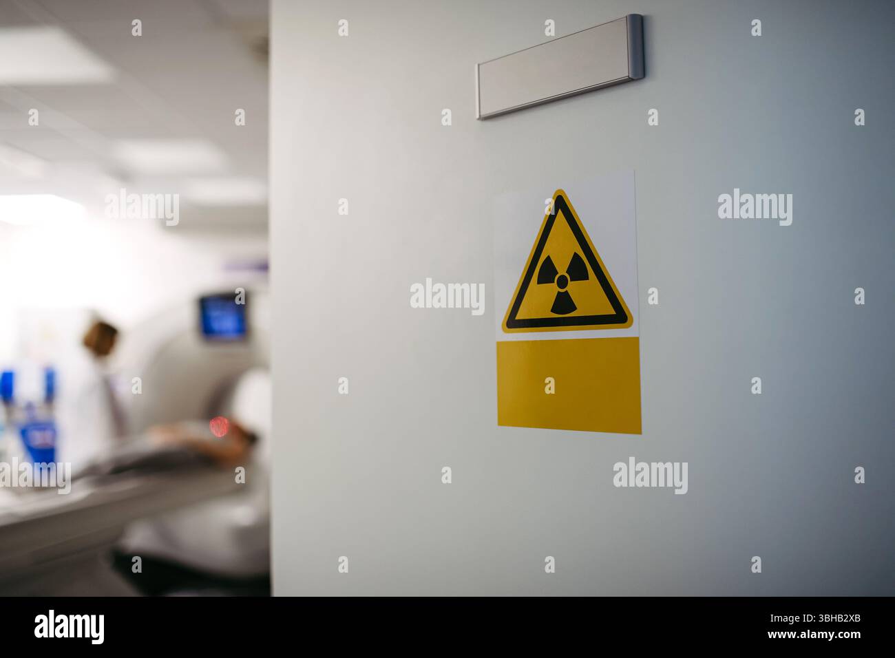 CT scan in progress behind radiation warning sign Stock Photo - Alamy