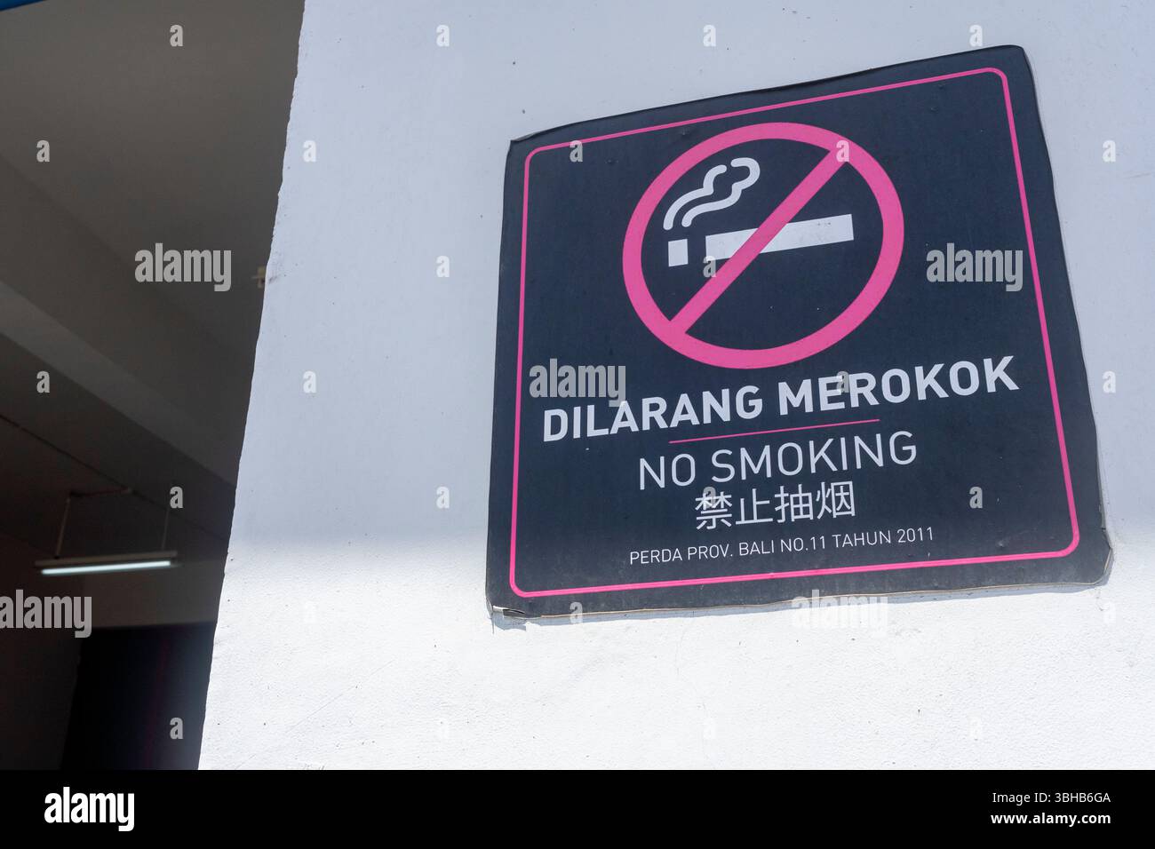 Sign that says no smoking in a foreign language. The sign is black and ...