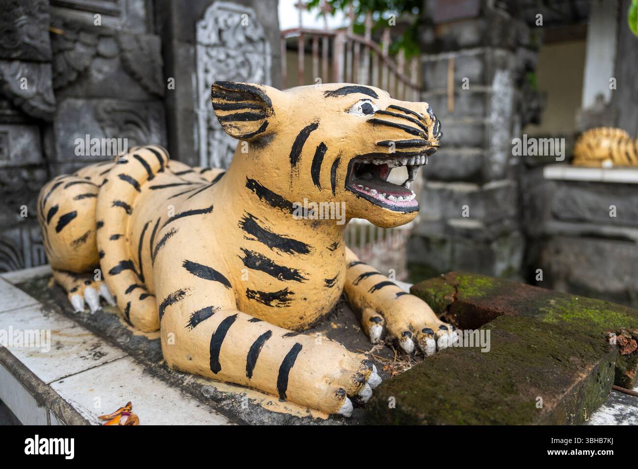 Bali, Indonesia - Dec 23, 2024: Tiger statue is laying on a stone wall ...