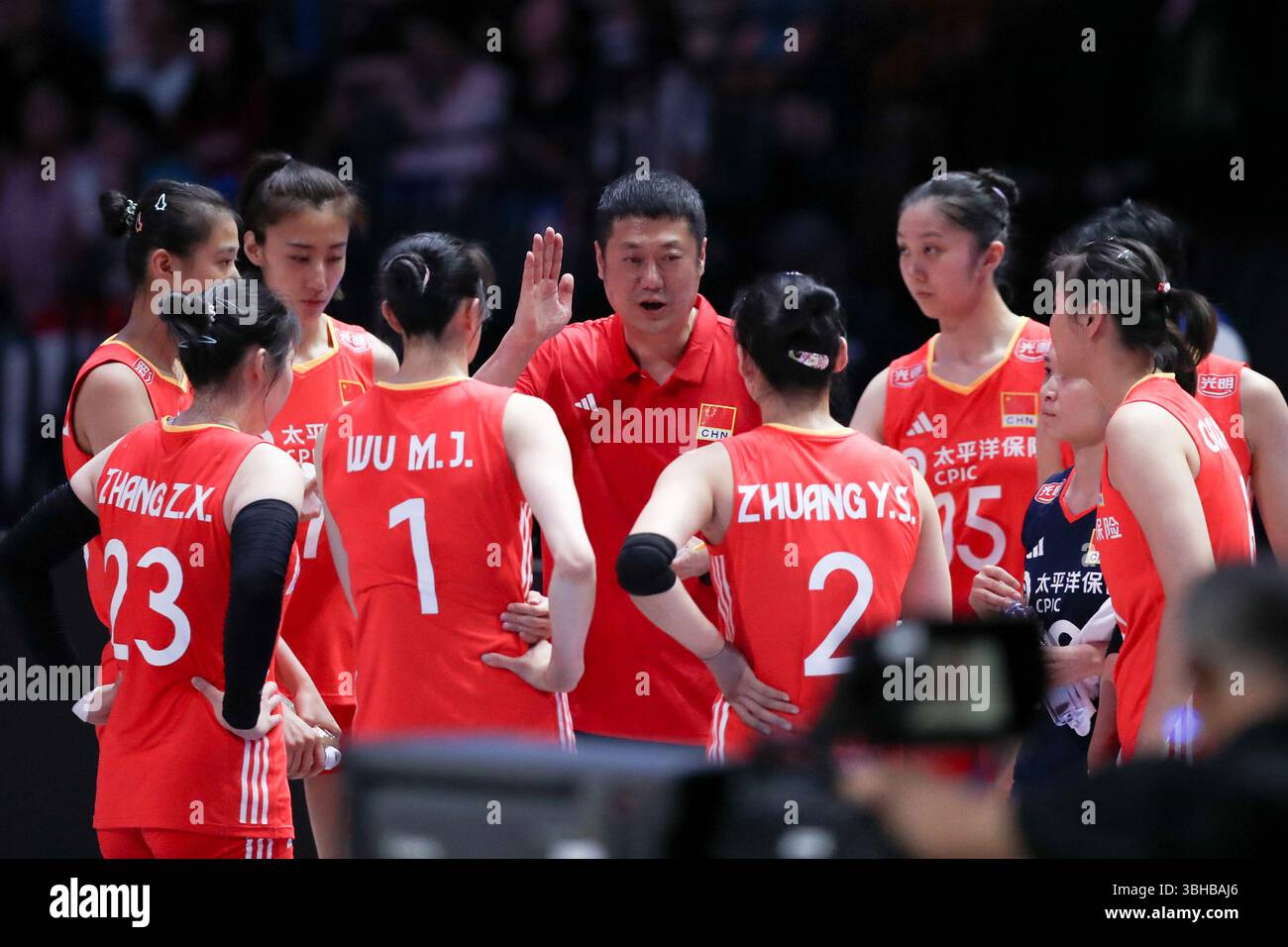 Coach Zhao Yong (center) gives tactical guidance to players during a ...