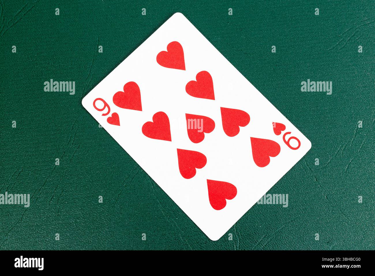 Nine of Hearts Playing Card on Green Surface Stock Photo - Alamy