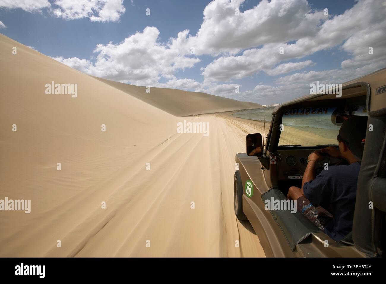 View from back of Dune buggy speeding along empty beach, Jericoacoara ...