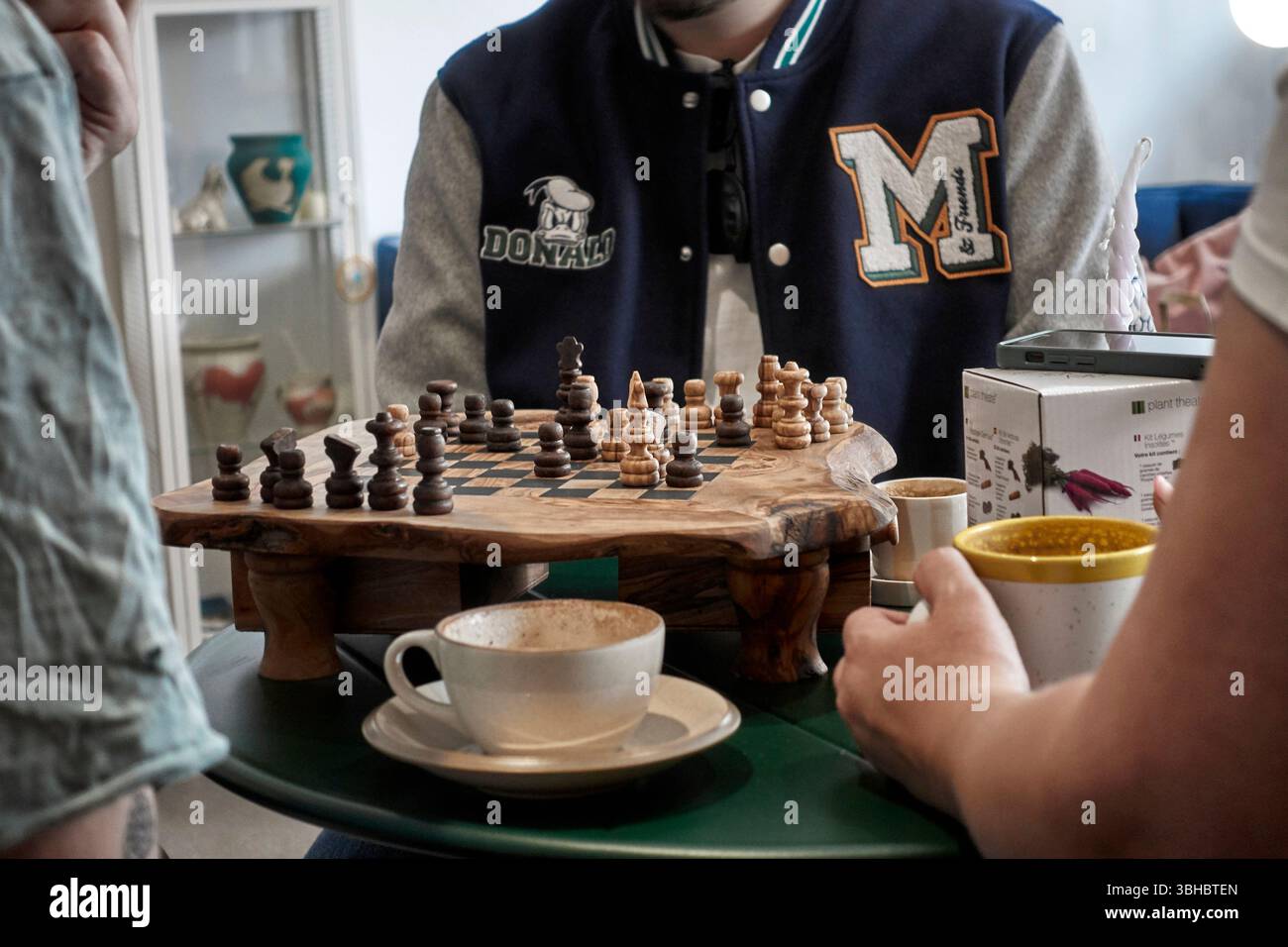 Chess players in a cafe. England, UK Stock Photo - Alamy