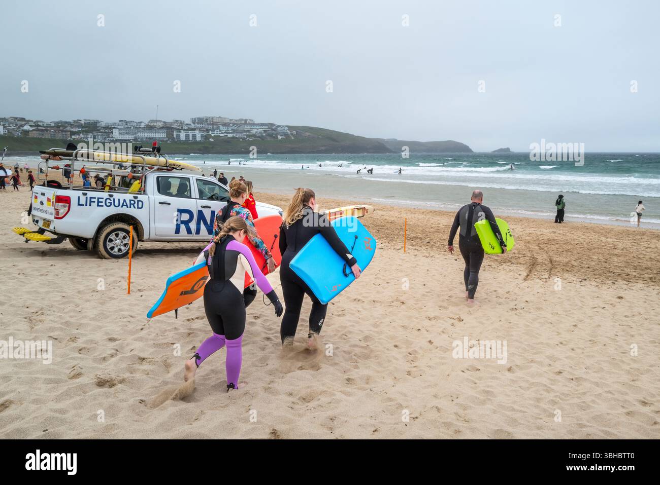 A family of holidaymakers eager to go body boarding at the world famous Fistral Beach in Newquay ...