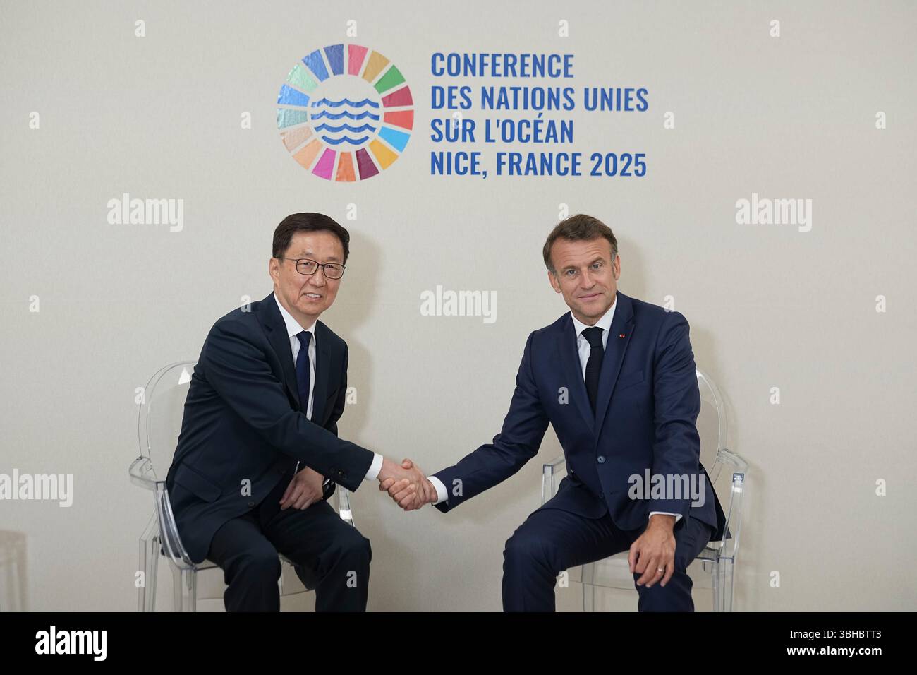China's Vice President Han Zheng, left, shakes hands with France's ...