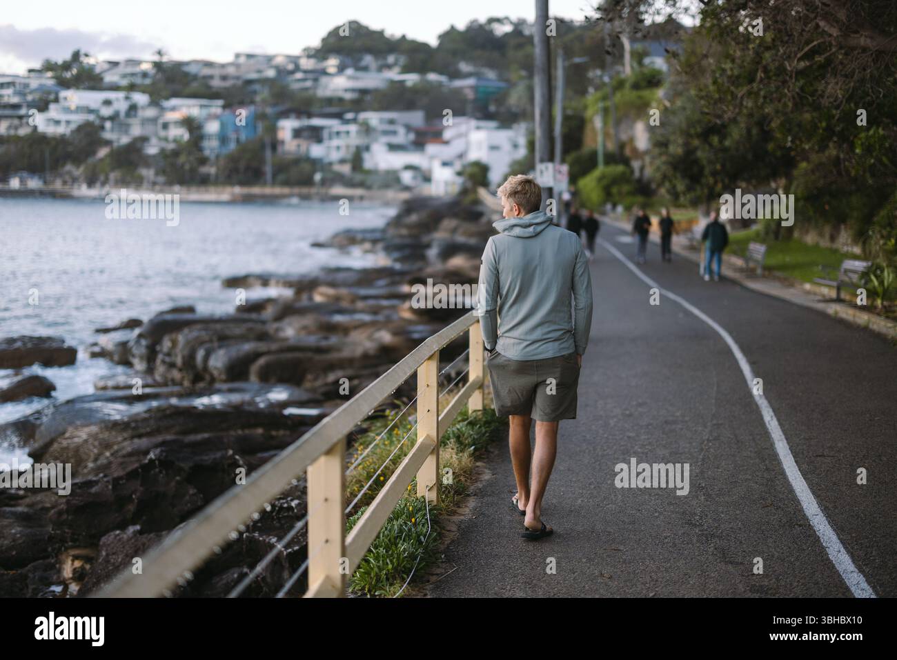 Man walking on manly beach promenade enjoying scenic views Stock Photo ...
