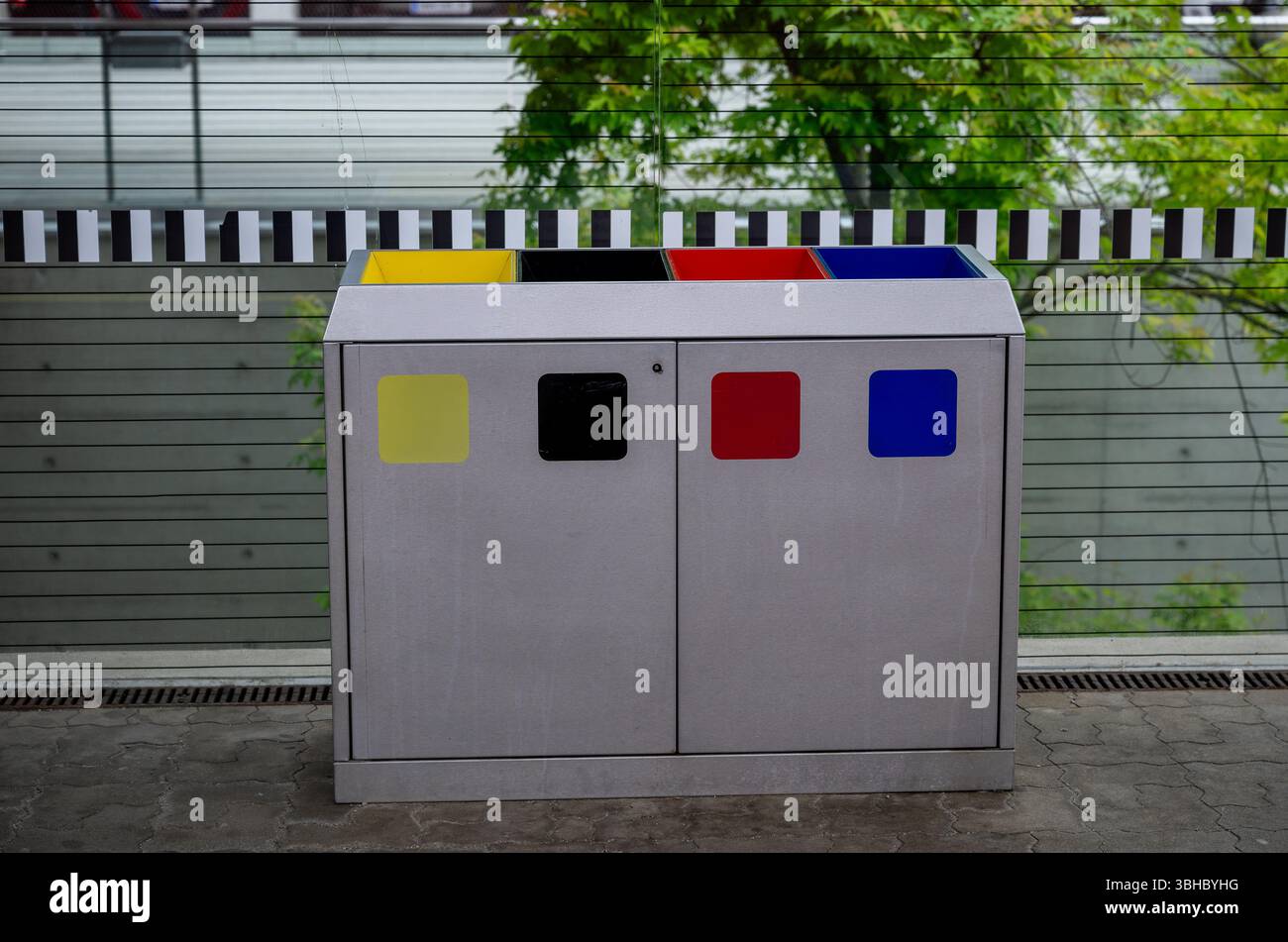 Modern recycling bin with color-coded sections for waste separation ...