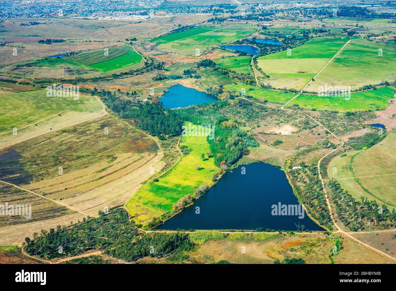 Aerial view of agricultural land adjoining a residential suburb in the ...