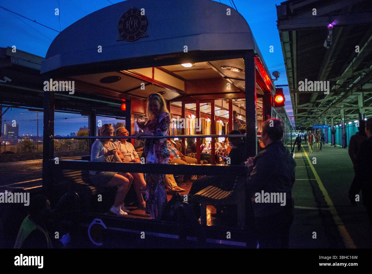 Passengers sit out on the open air part of the observation car as The ...