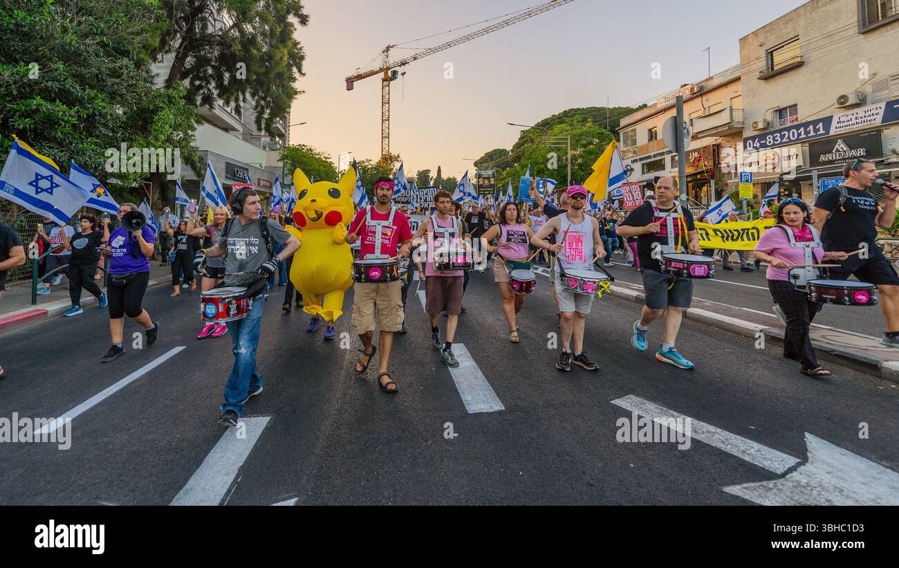 Haifa, Israel - June 07, 2025: People take part in a protest march ...