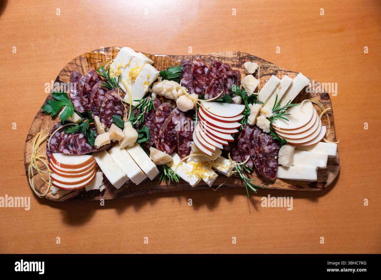 A charcuterie board with beautifully arranged selection of cured meats ...