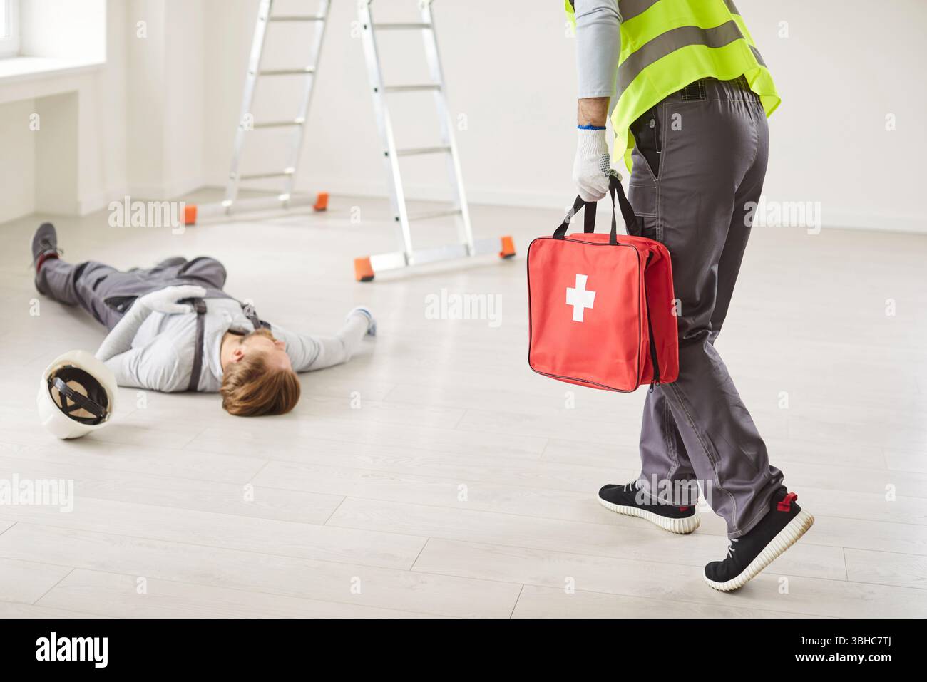 Man going give first aid to injured unconscious man constructor lying ...