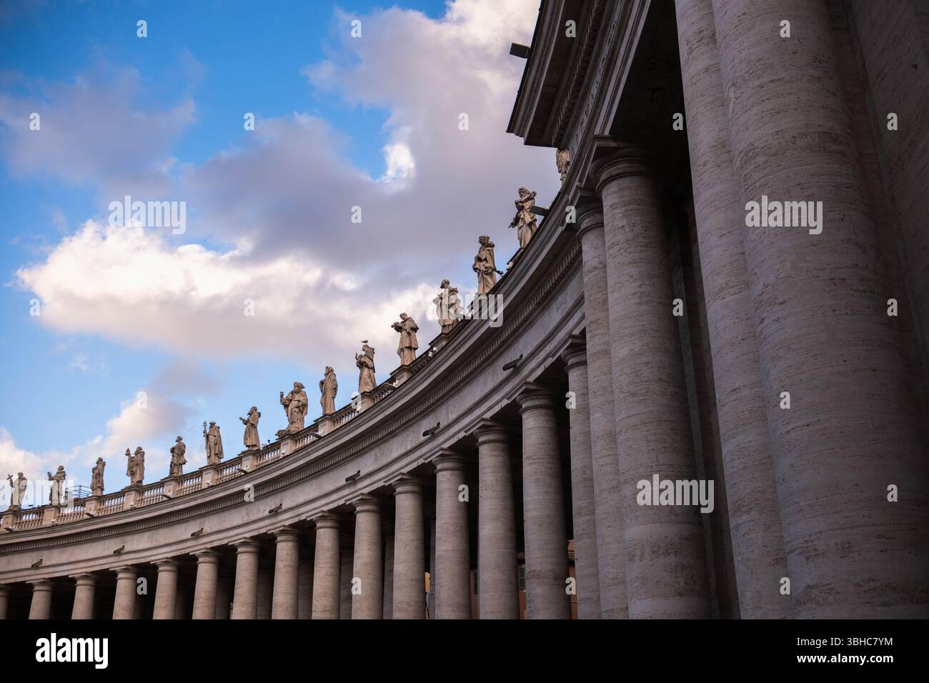 Colonnades of St. Peter's Square in the Vatican. Tall massive columns ...