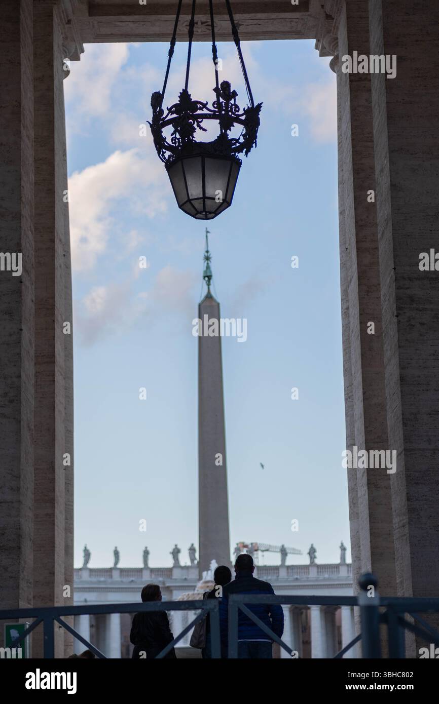 Columns in the Vatican, through which the Vatican Obelisk is visible in St. Peter's Square in ...