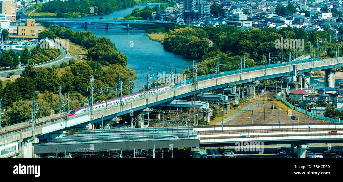 Tohoku Shinkansen bullet train travels over the Kitakami River with the ...