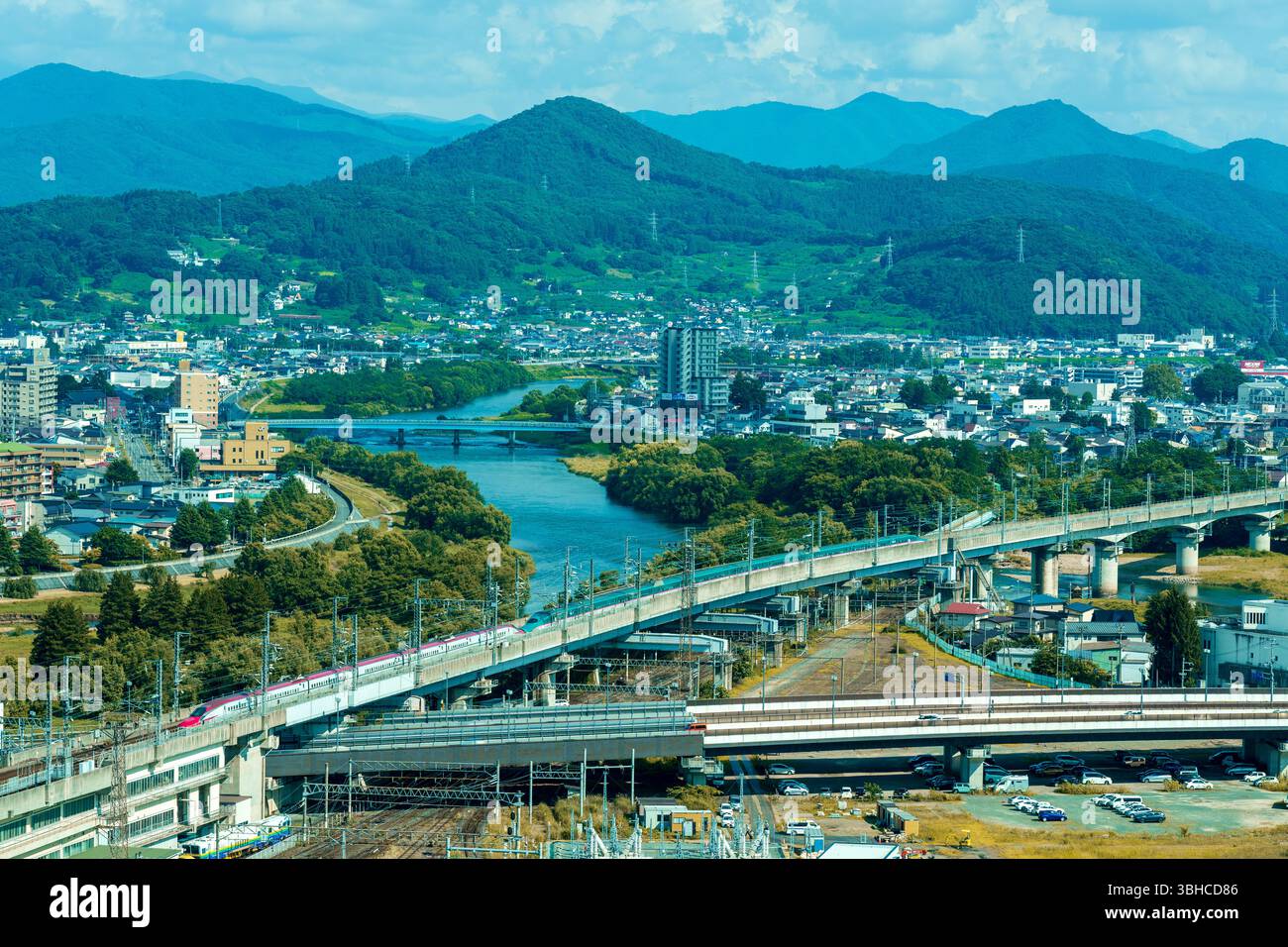 Tohoku Shinkansen bullet train travels over the Kitakami River with the ...