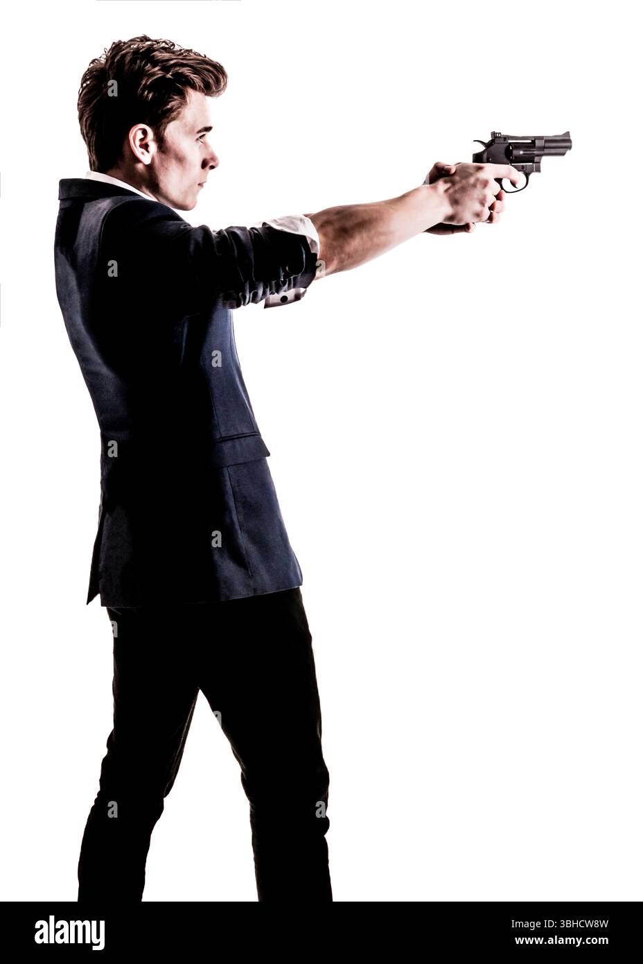 A man in a suit aims a revolver Stock Photo - Alamy