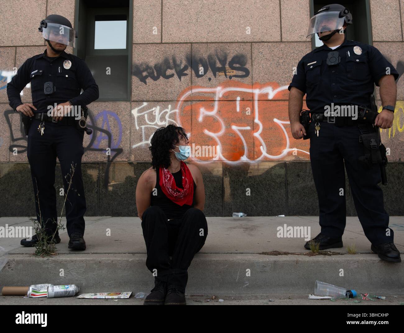 LAPD officers detain Anti-Ice protester as they push the group away ...