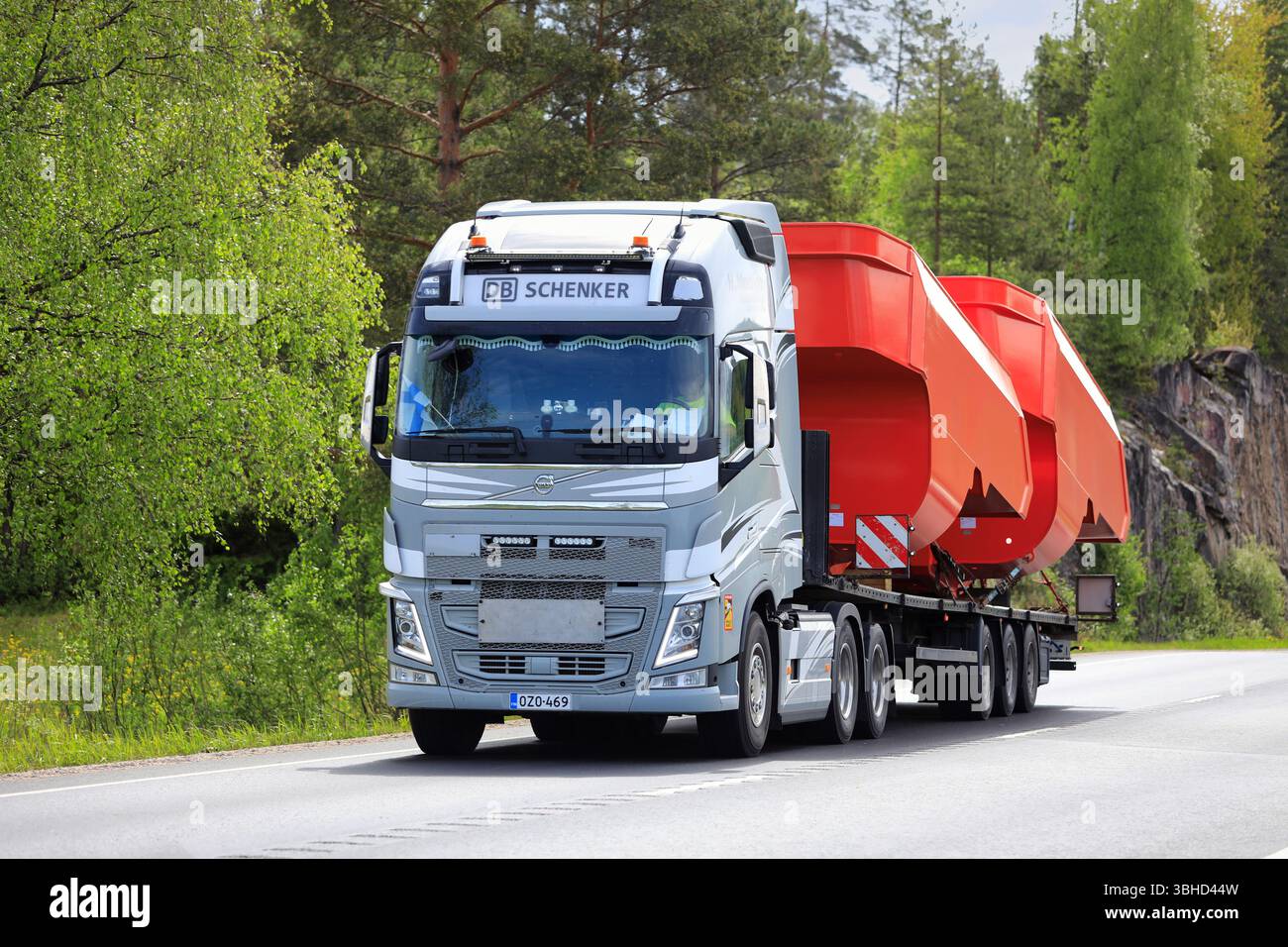 Volvo FH truck transports two mining truck bodies on flatbed trailer as ...