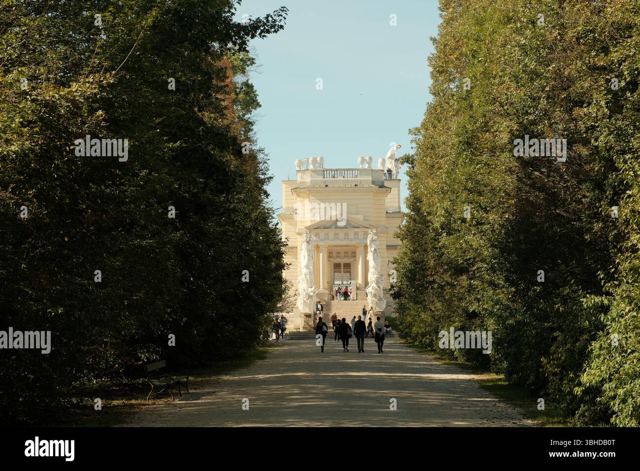 Visitors walk along a tree-lined avenue toward the Gloriette at ...