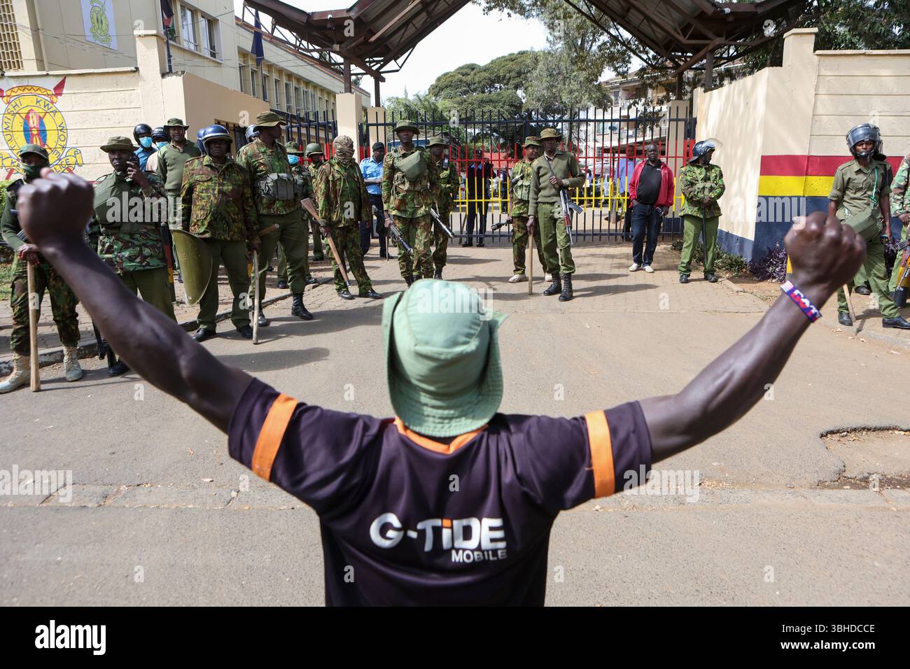 Kenyan police stand guard as a demonstrator reacts to the death of Kenyan blogger Albert Ojwang ...