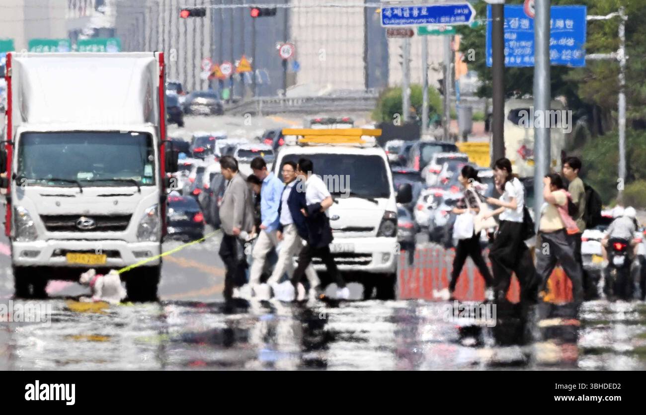 Heatwave hits Seoul People walk on a street in Seoul, South Korea, June 9, 2025. The Korea ...