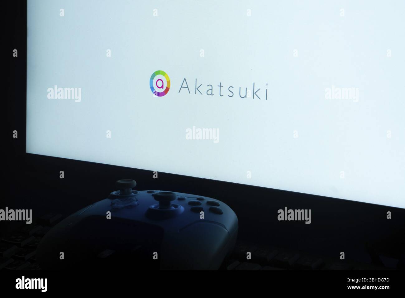 Screen displays Akatsuki logo above a gaming controller Stock Photo - Alamy