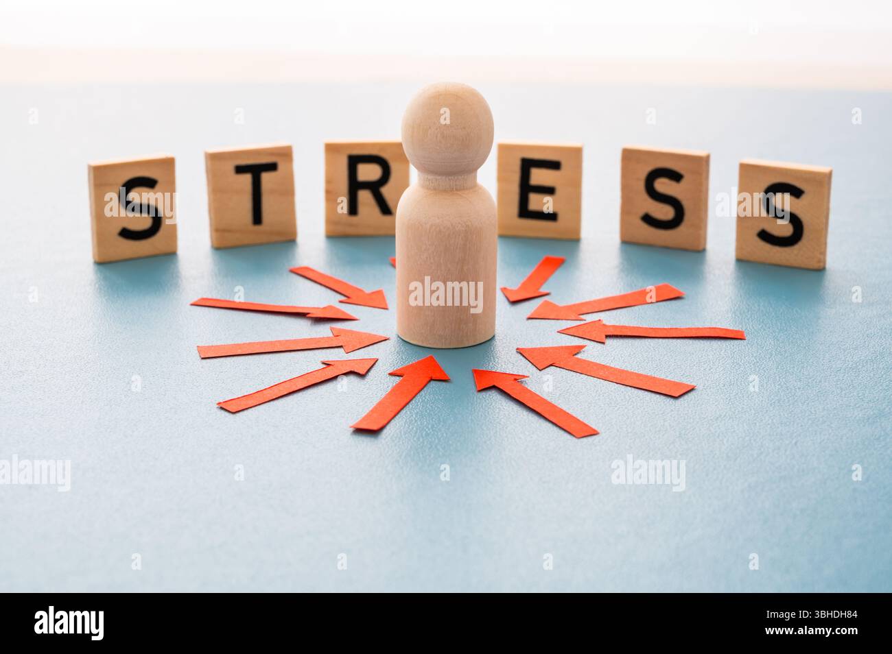 Stress concept and stressed person. Wooden figure with red arrows ...