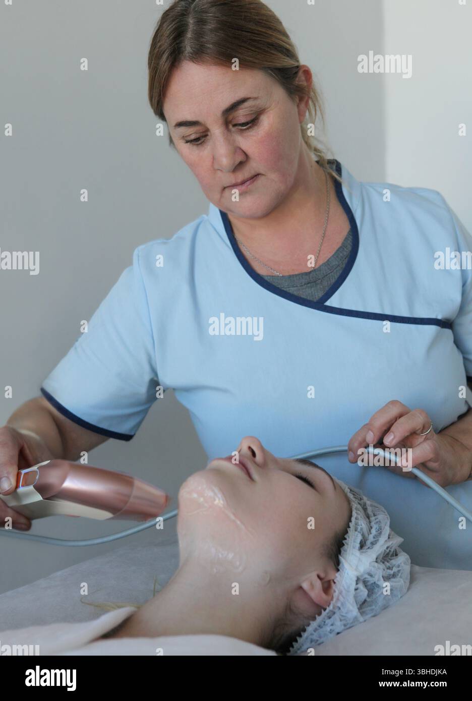 closeup portrait of young woman receives a HIFU (High-Intensity Focused ...