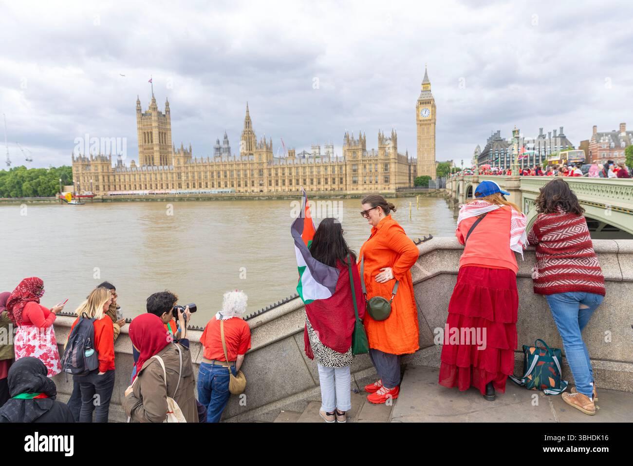 Pro-Palestinian protesters wearing red create a red line for Palestine ...