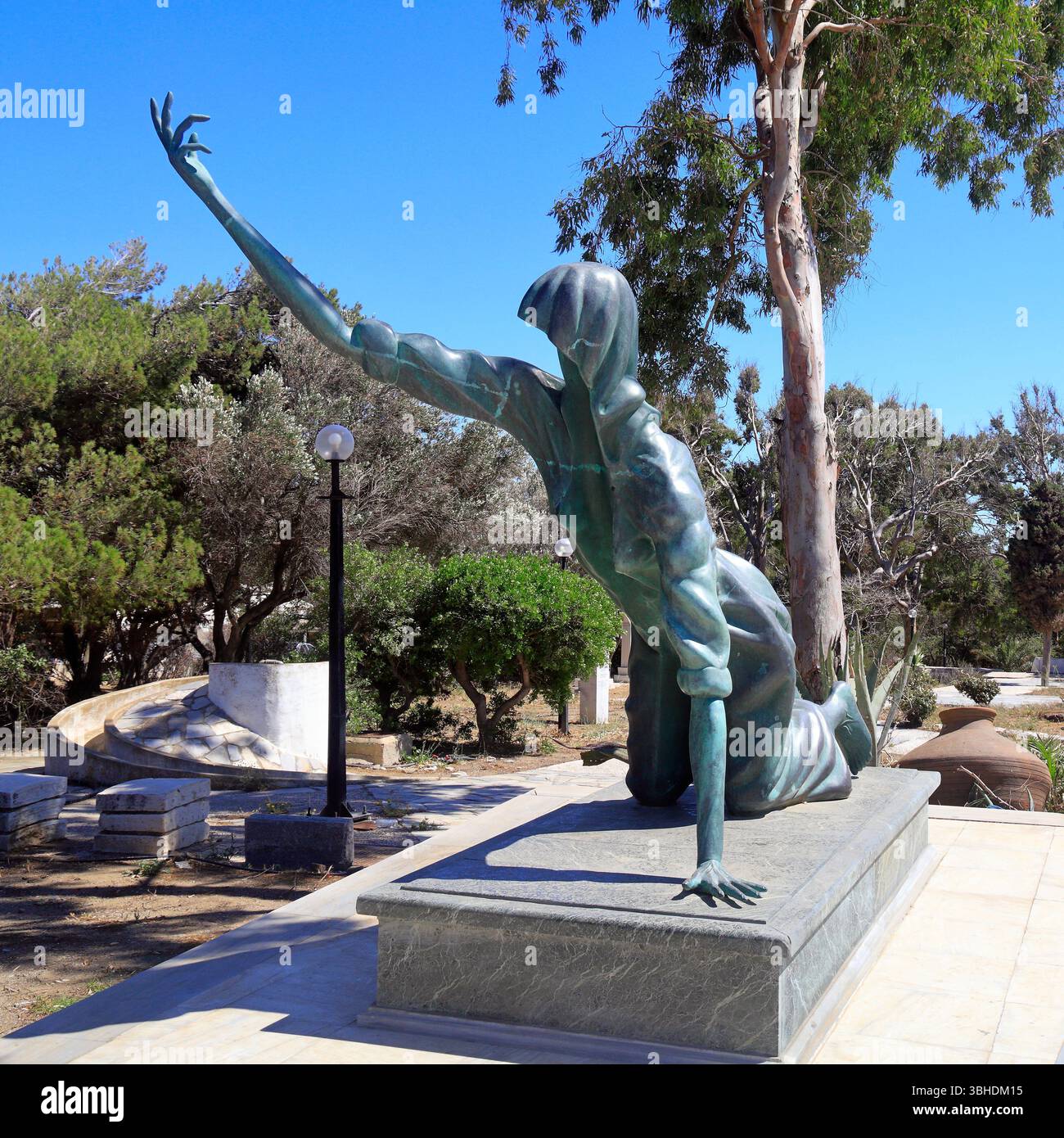 Bronze statue of a figure on hands and knees crawling to the Panagia ...