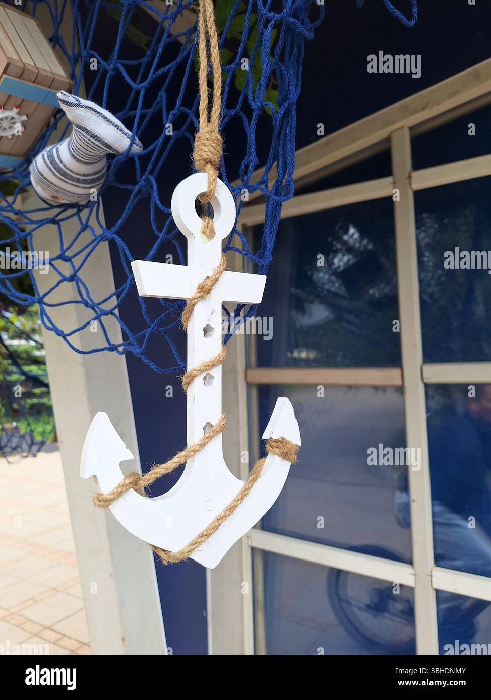 Nautical decor with white anchor on blue fishing net background Stock ...
