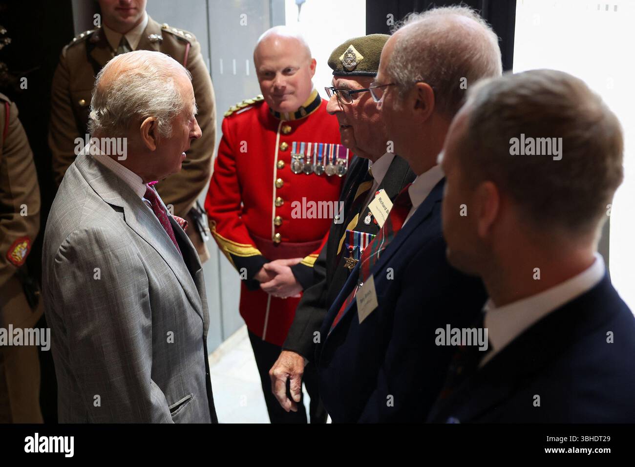 King Charles III talks with 101-year-old veteran Richard Brock during a ...