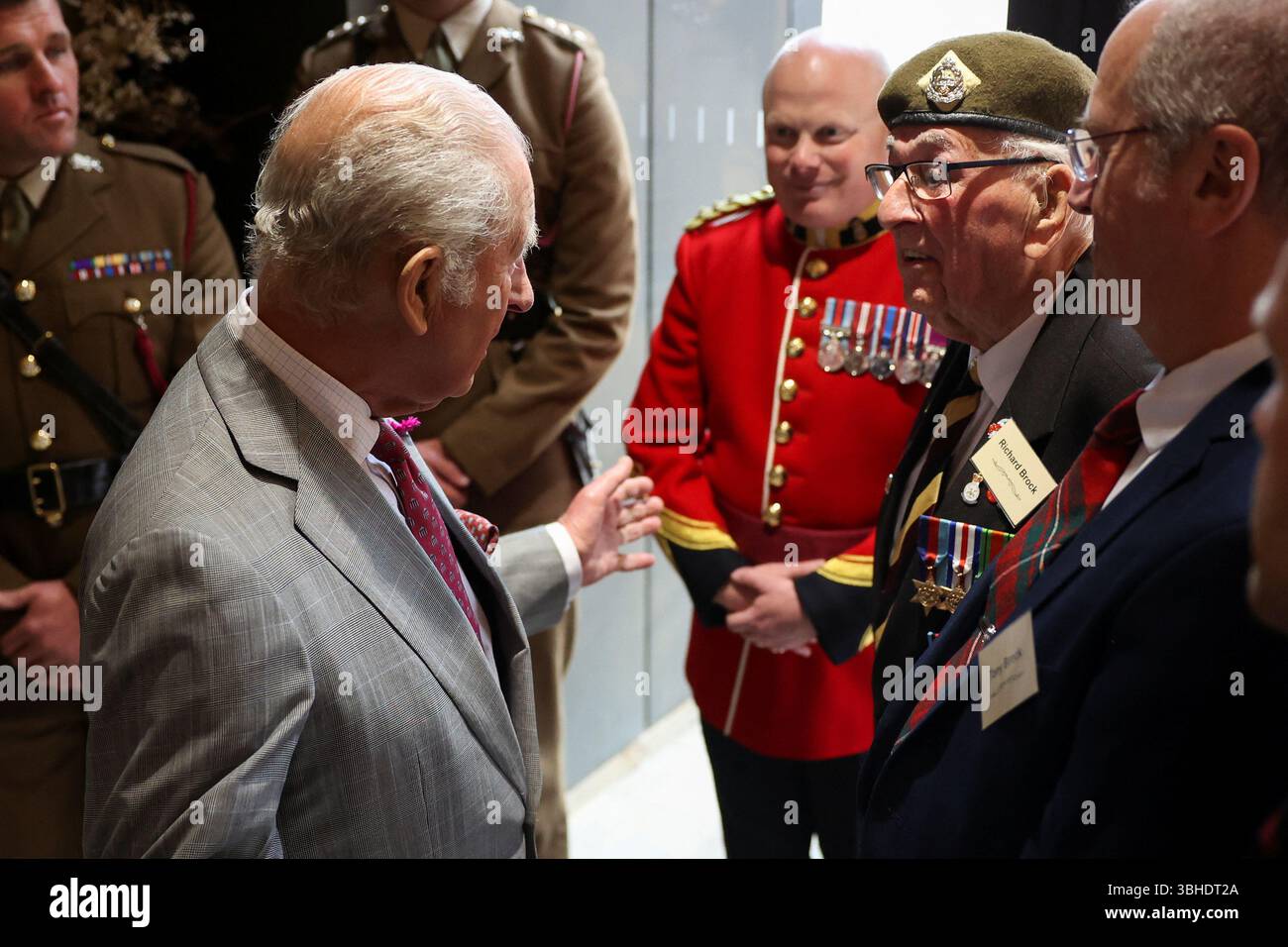 King Charles III talks with 101-year-old veteran Richard Brock during a ...