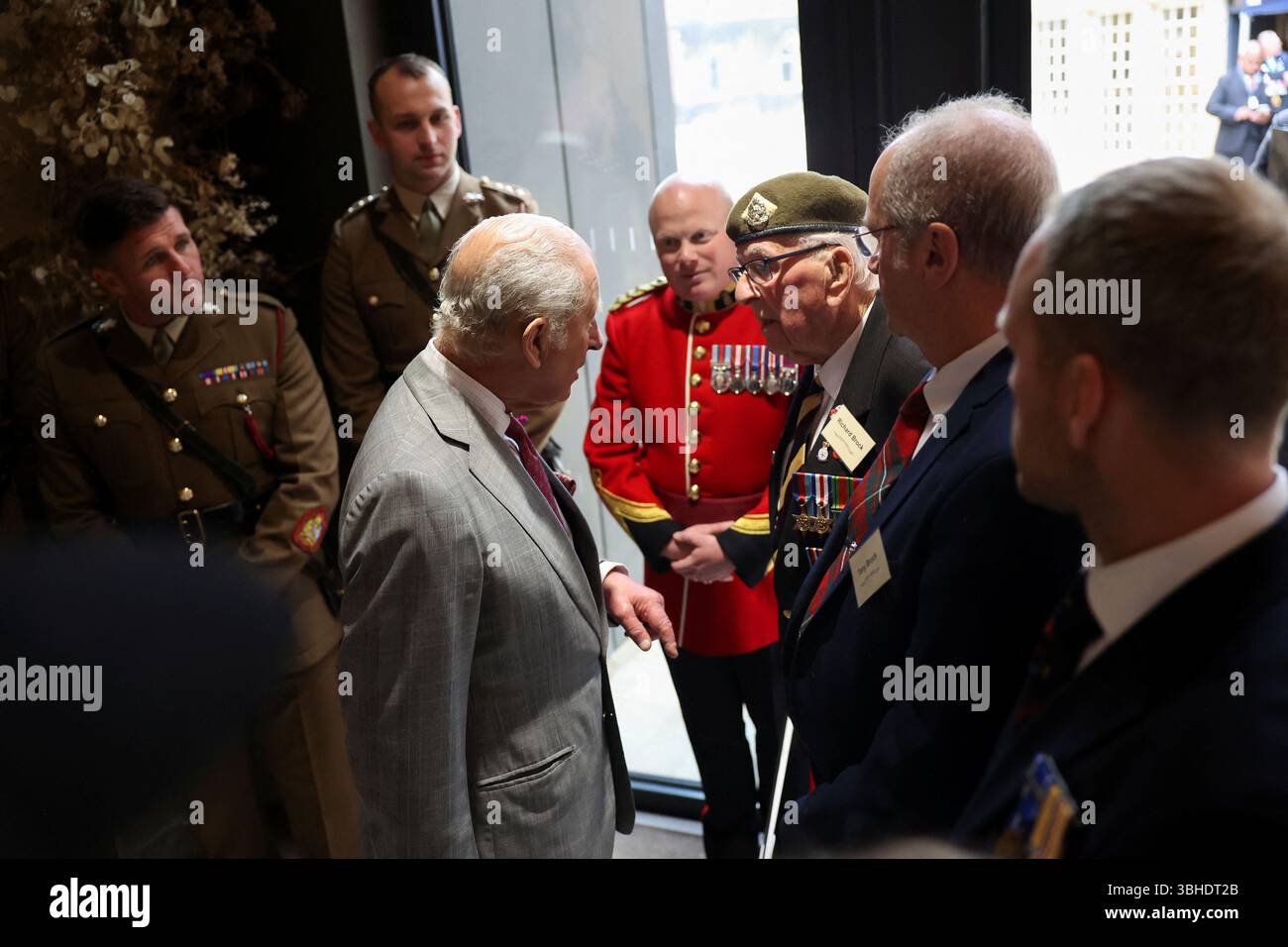 King Charles III talks with 101-year-old veteran Richard Brock during a ...